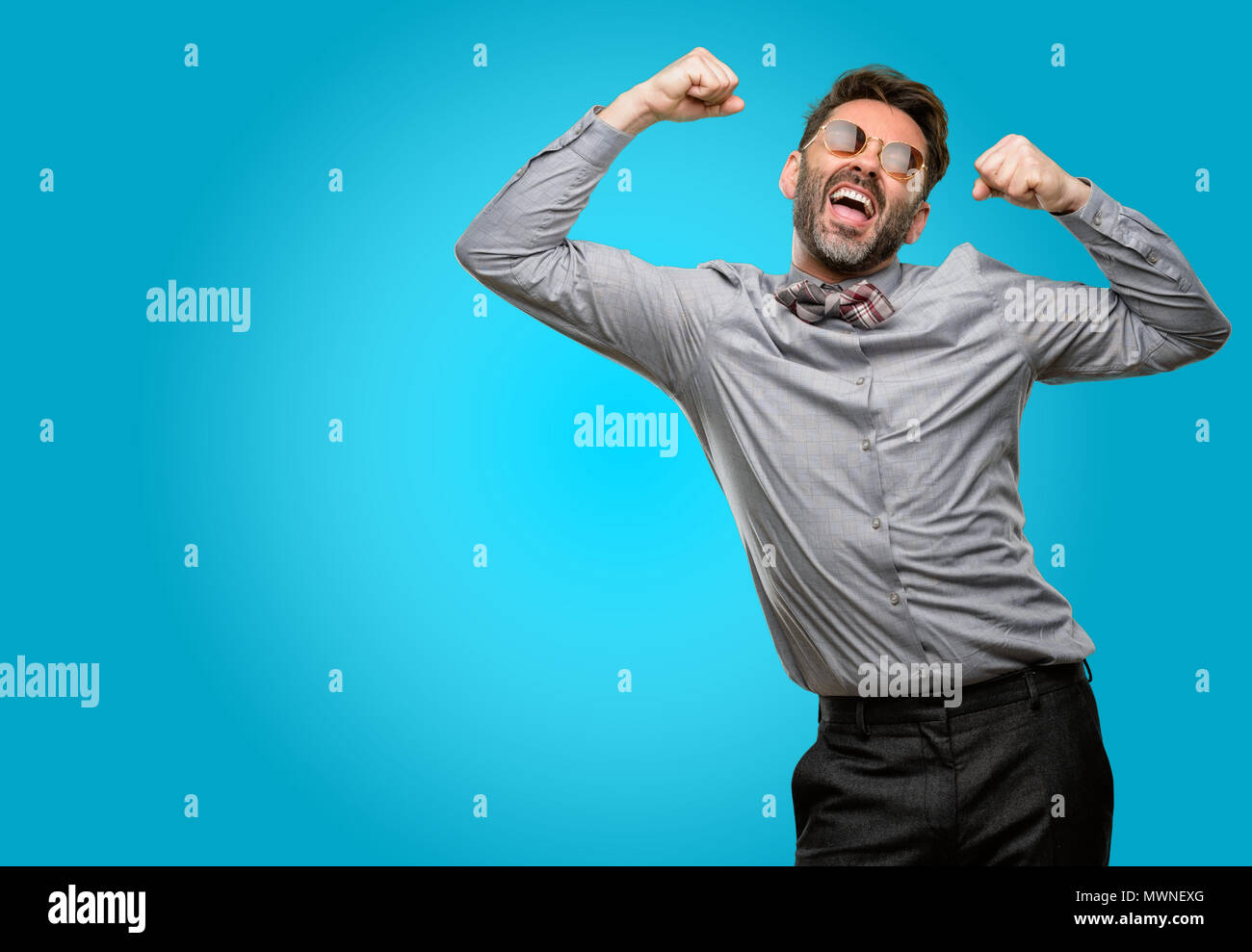 Middle age man, with beard and bow tie happy and excited celebrating ...