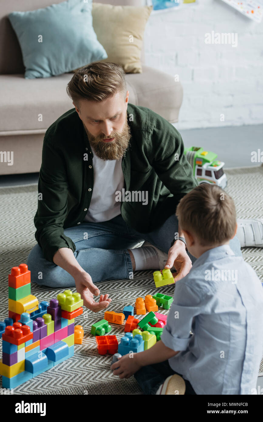 family playing with colorful blocks together at home Stock Photo - Alamy