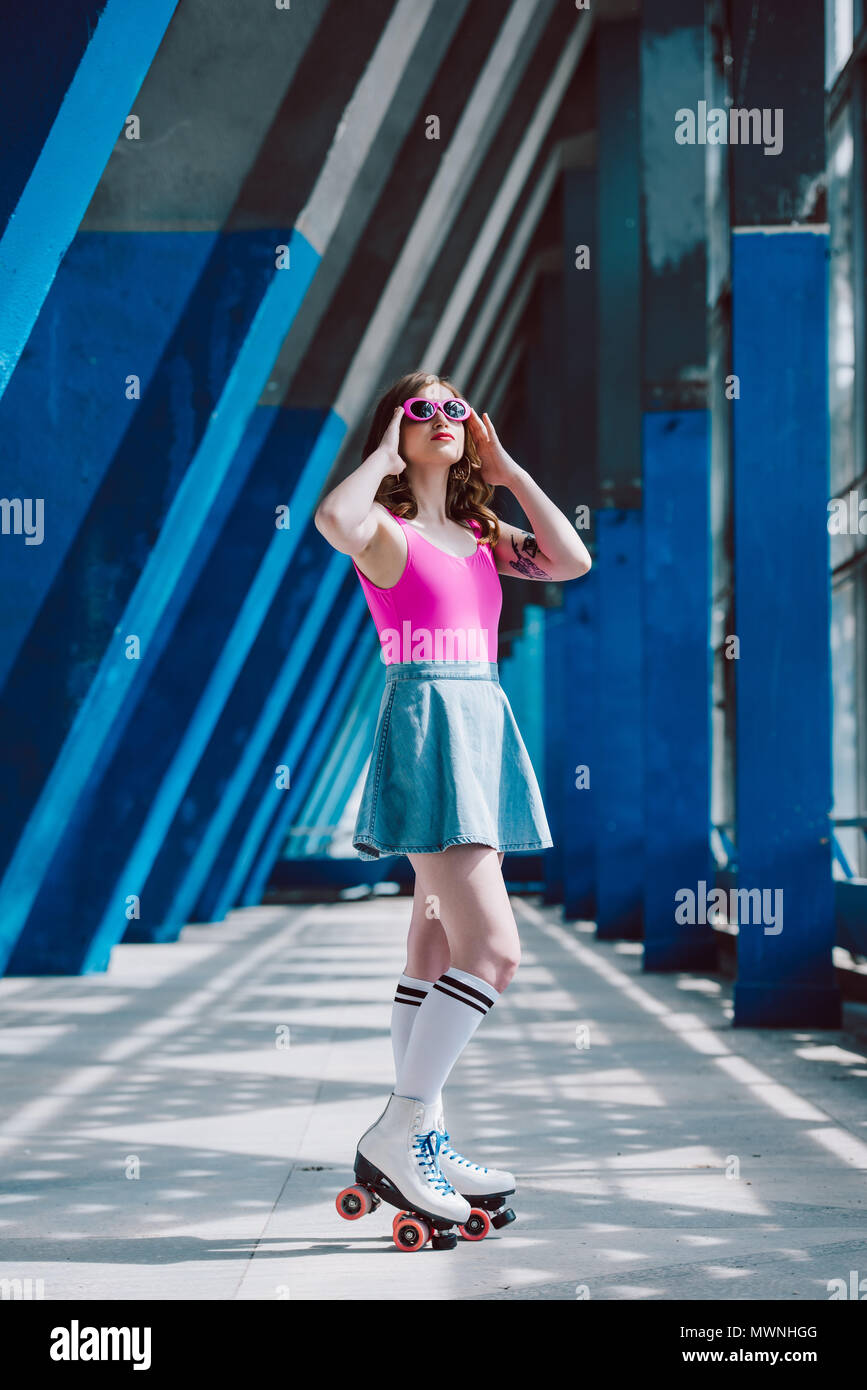 Full Length View Of Stylish Girl In Vintage Roller Skates Looking Up On