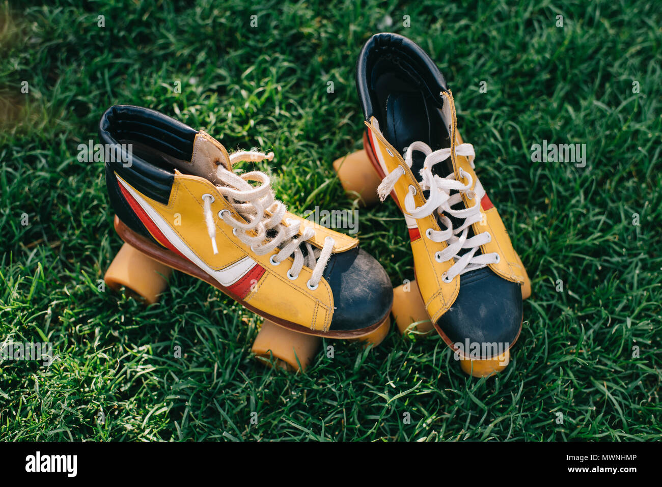 close-up view of vintage roller skates on green grass Stock Photo - Alamy