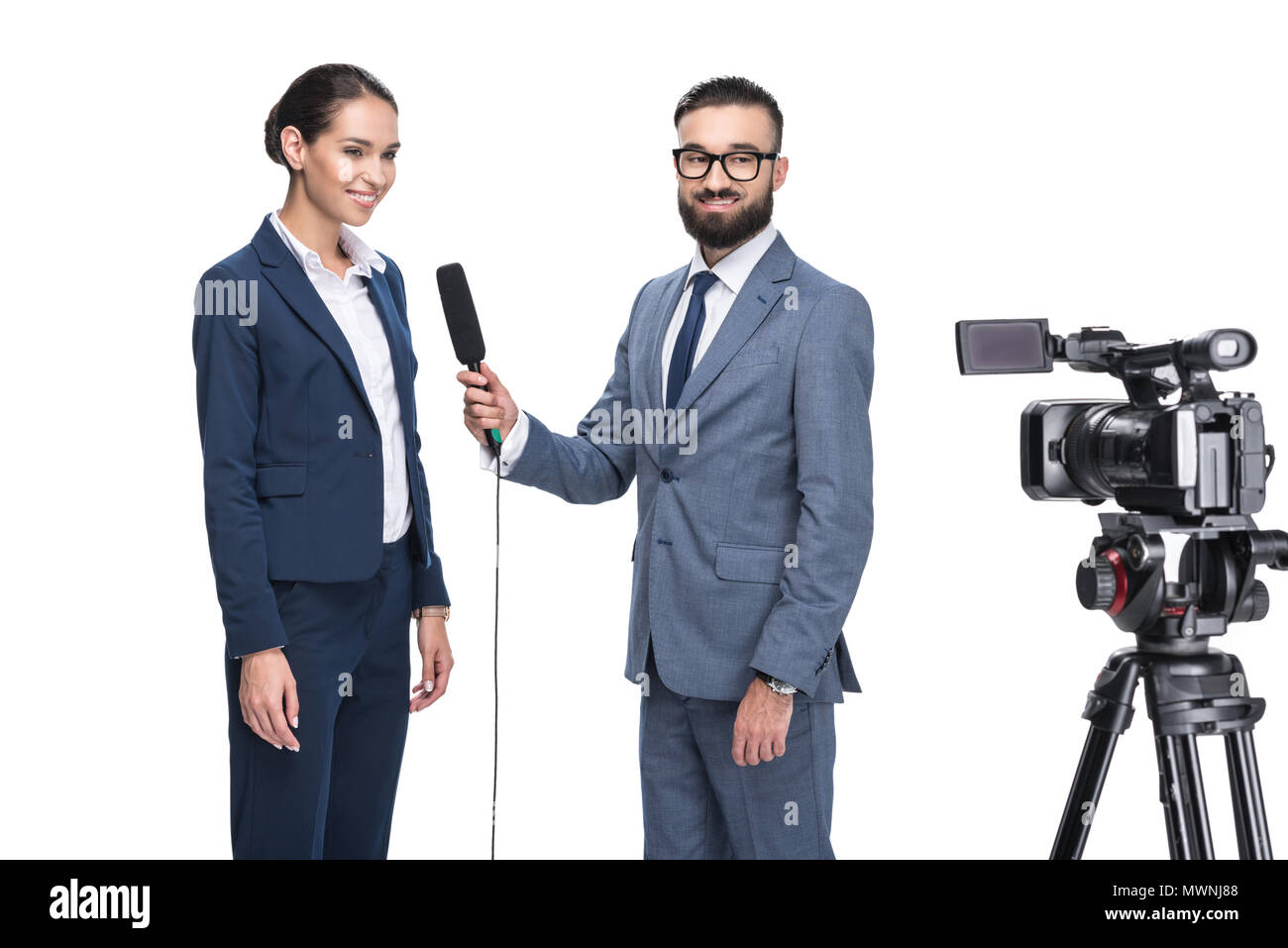 male journalist with microphone and video camera taking interview with ...
