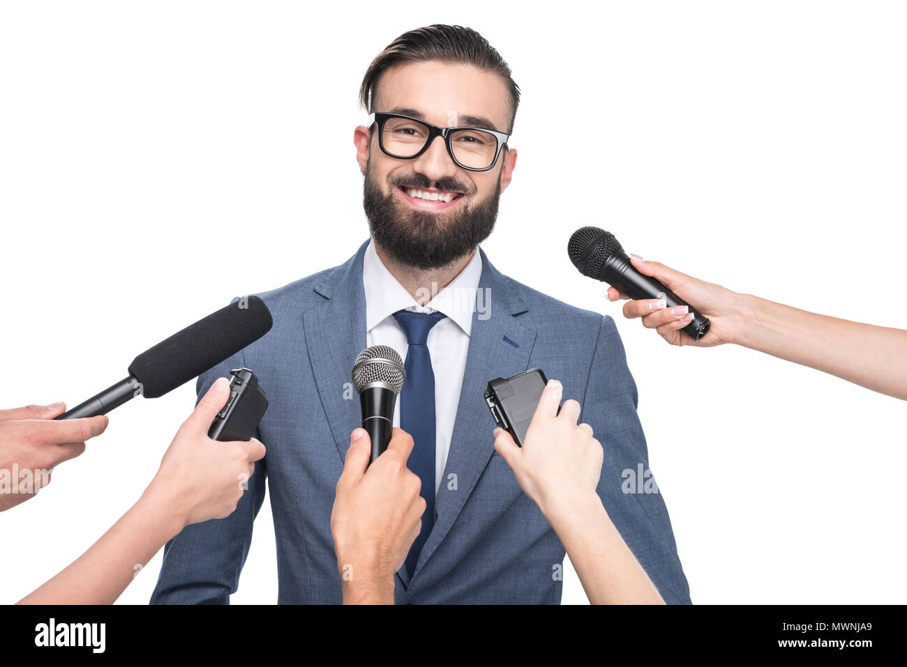 journalists with microphones interviewing smiling handsome businessman ...