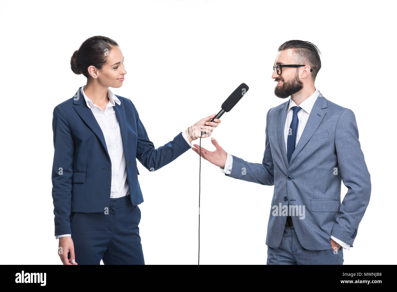 smiling female journalist interviewing businessman in suit, isolated on ...