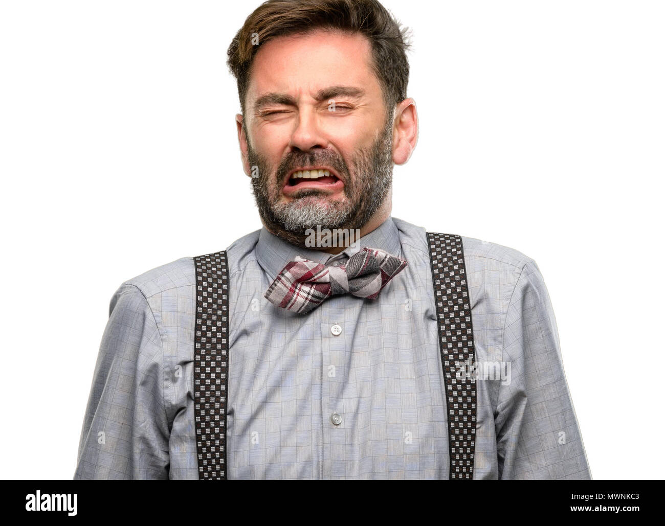 Middle age man, with beard and bow tie crying depressed full of sadness ...