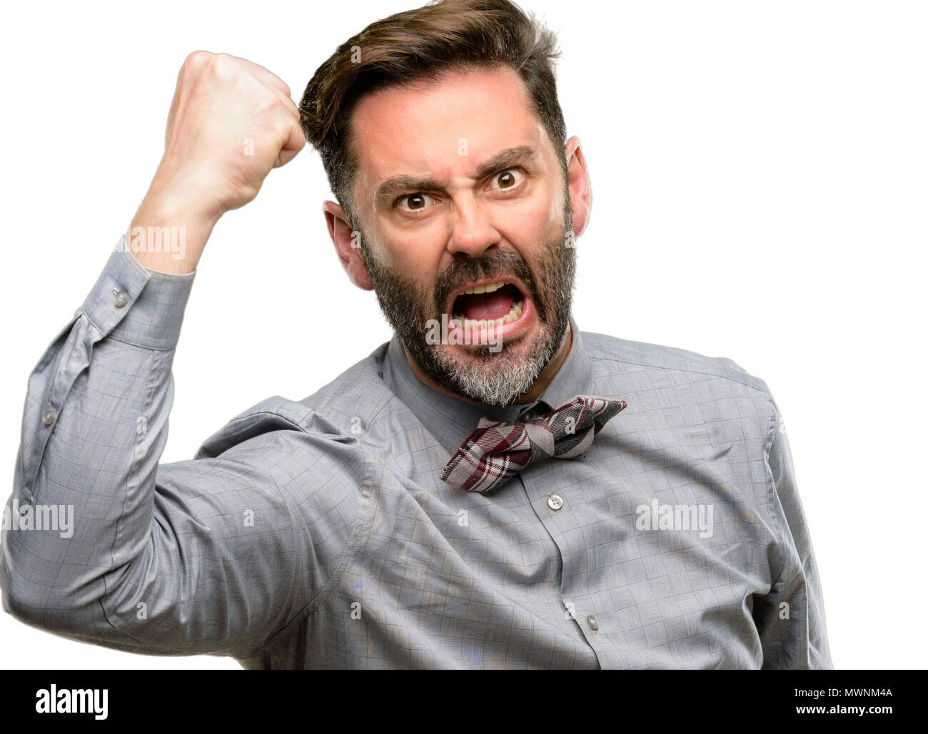 Middle age man, with beard and bow tie irritated and angry expressing ...