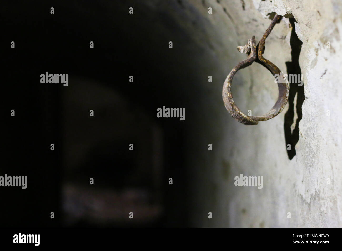 old hand chains in castle basement Stock Photo - Alamy