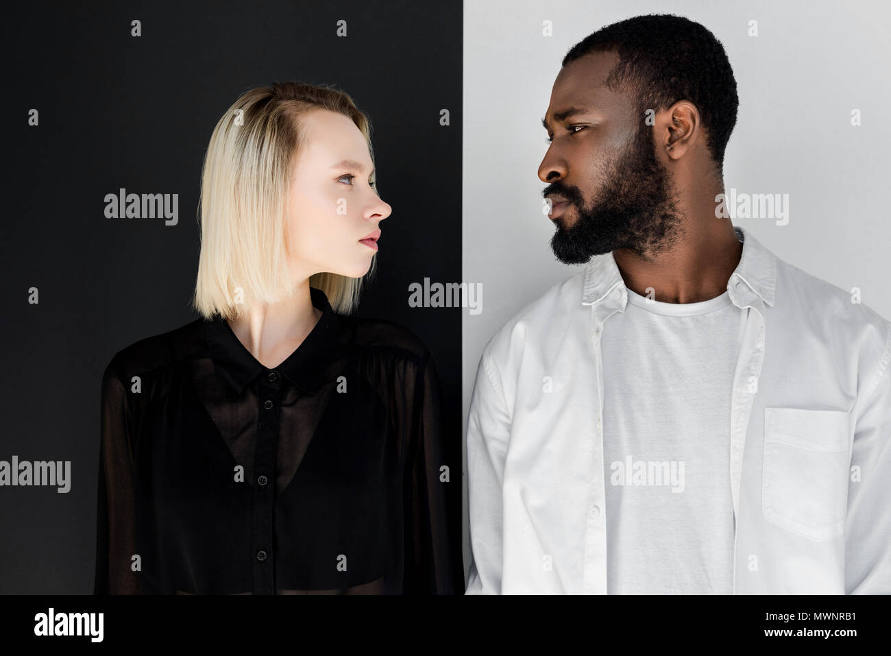 side view of multicultural couple looking at each other Stock Photo - Alamy