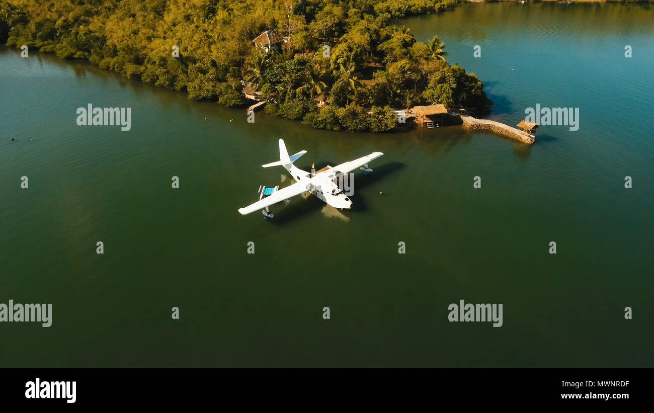 Aerial view: White Seaplane parked in the sea bay of the tropical ...