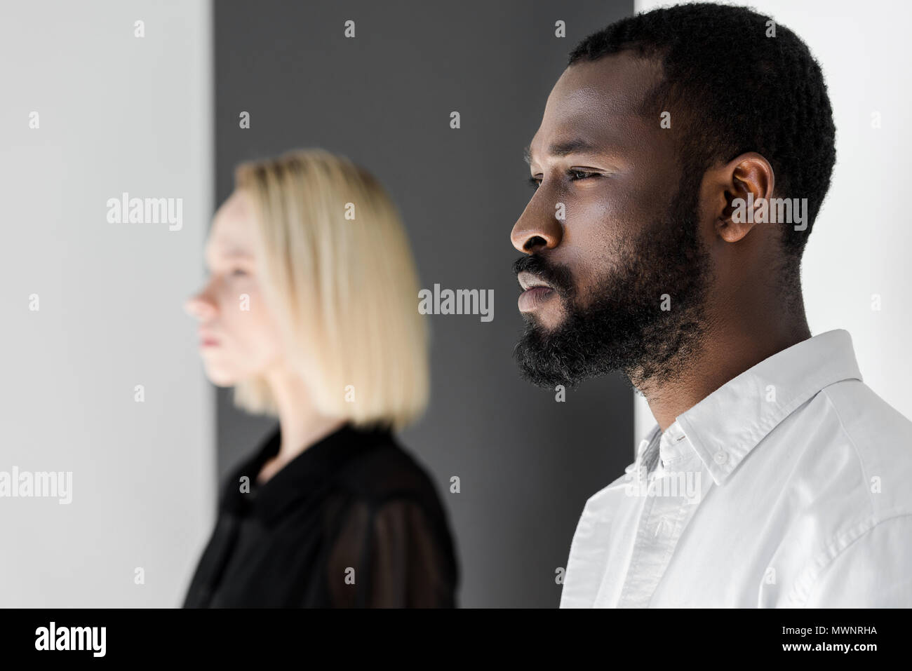side view of african american boyfriend and blonde girlfriend looking ...