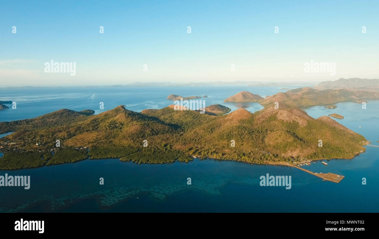 Aerial view: beach, tropical island, sea bay and lagoon, mountains with ...