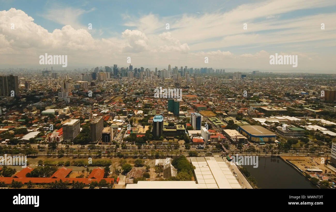 Aerial view of Manila city. Fly over city with skyscrapers and ...