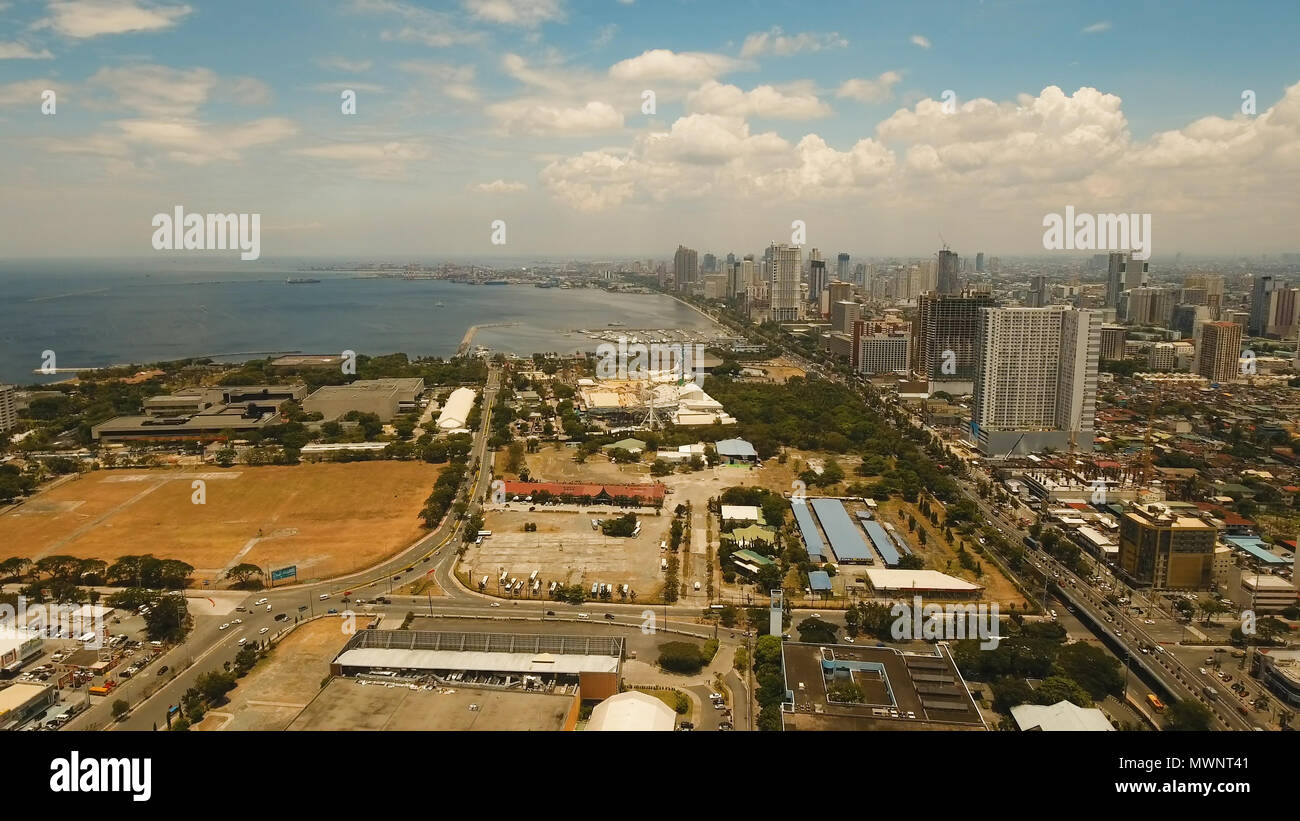 Aerial view of Manila city. Fly over city with skyscrapers and ...