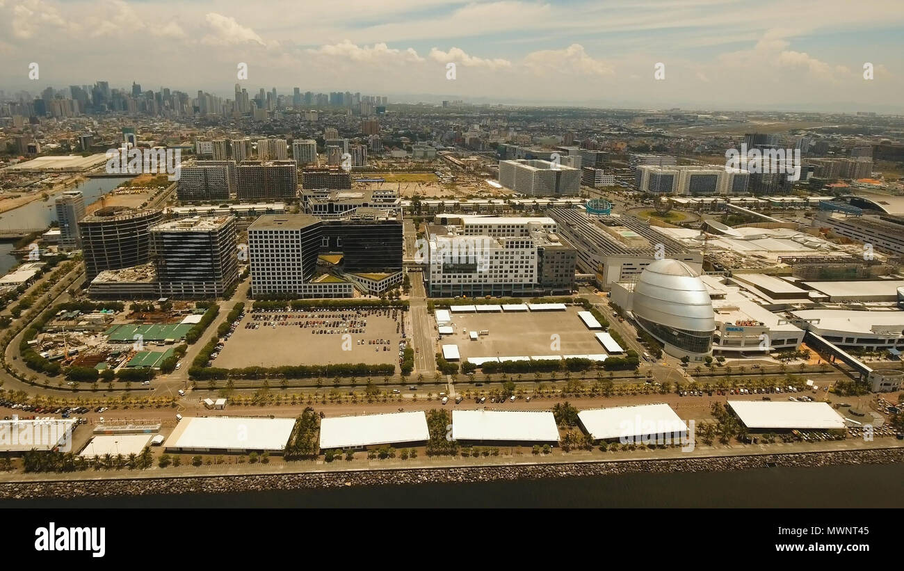 Aerial view of Manila city. Fly over city with skyscrapers and ...