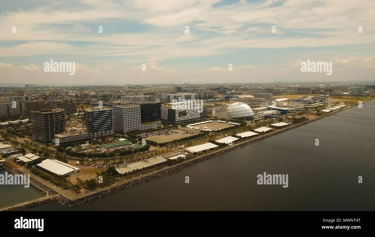 Aerial view of Manila city. Fly over city with skyscrapers and ...