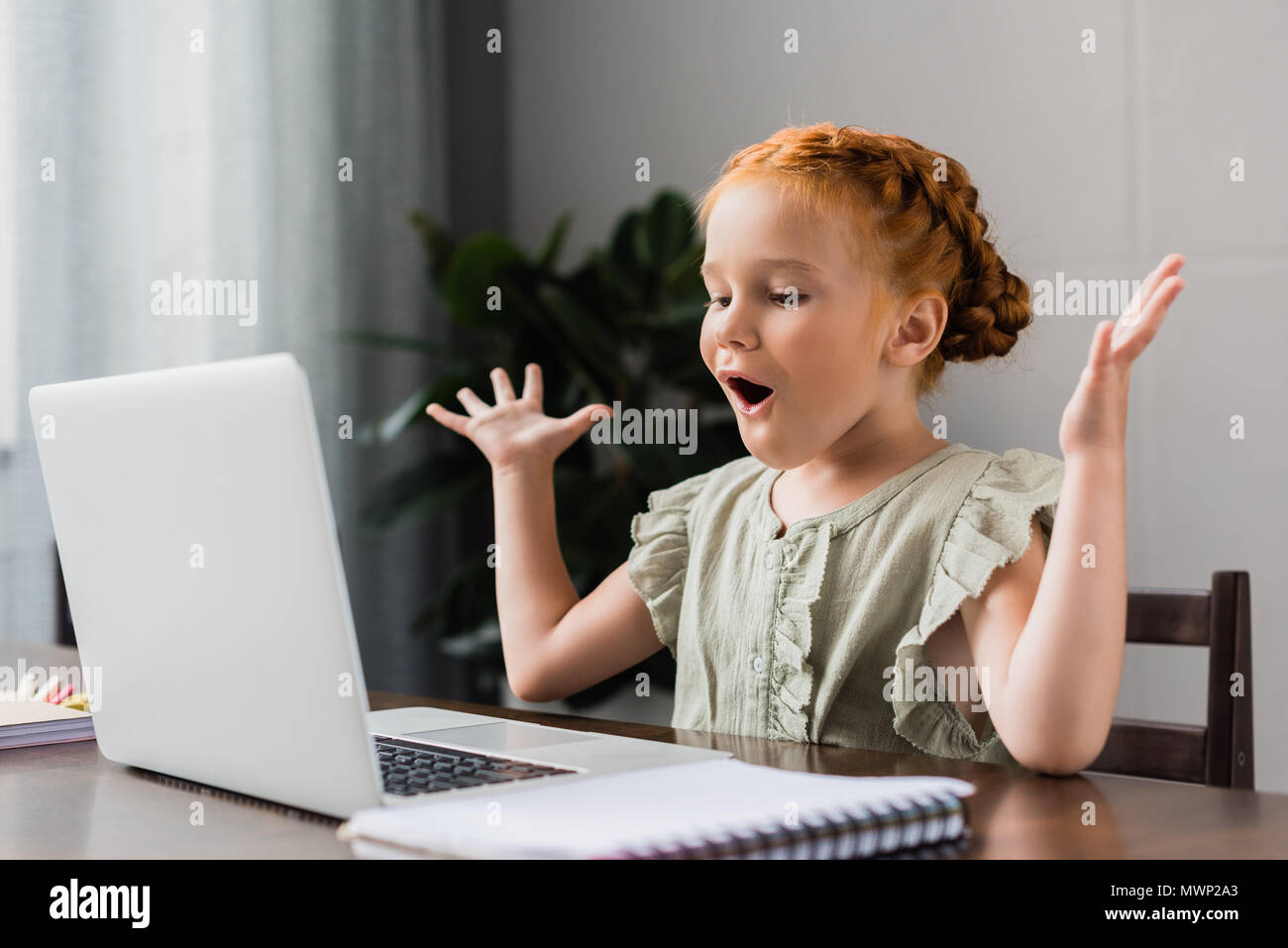 beautiful surprised little girl with laptop Stock Photo - Alamy