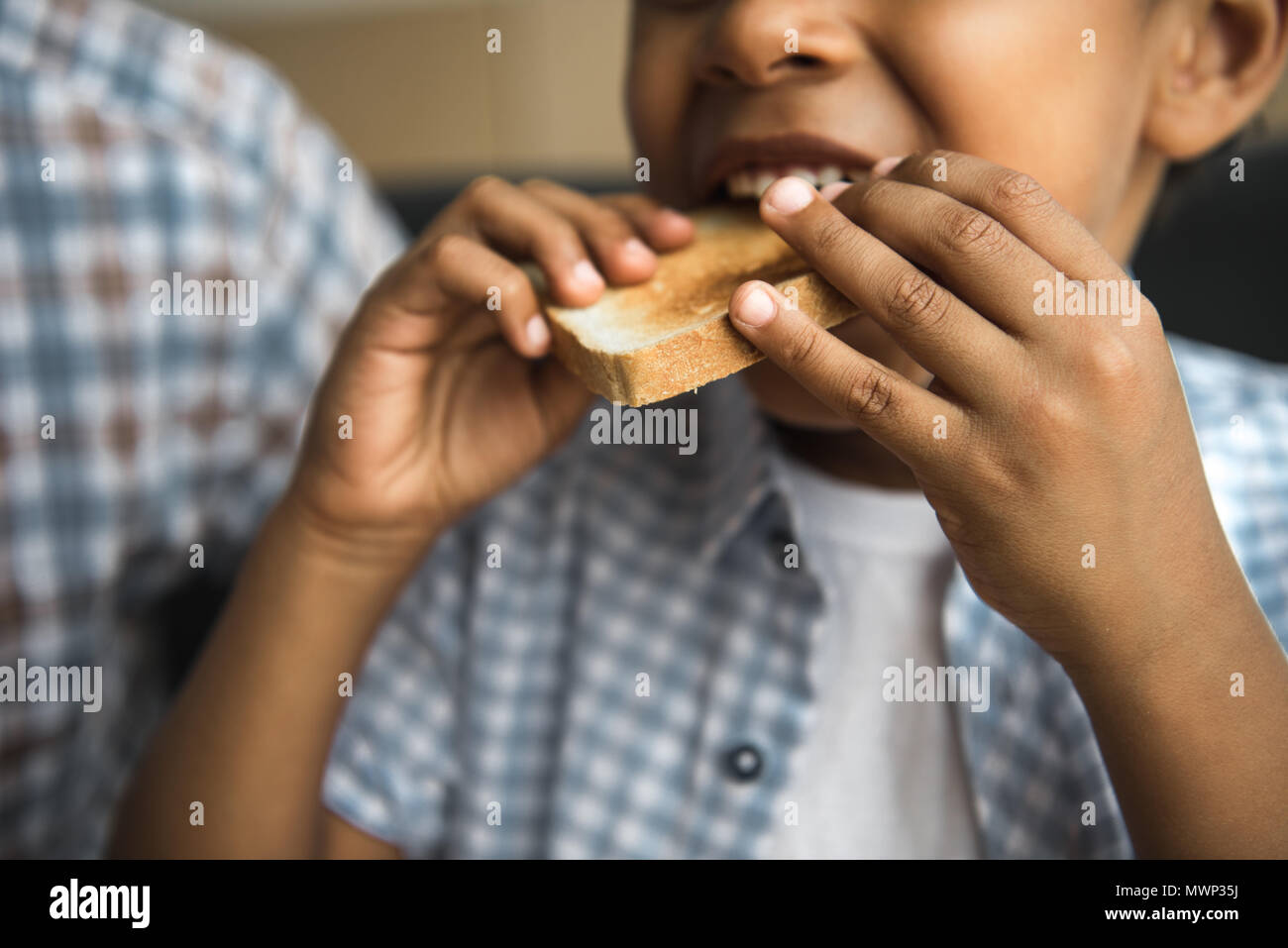 close-up partial view of smiling african american child eating toast ... close-up partial view of smiling african american child eating toast ...