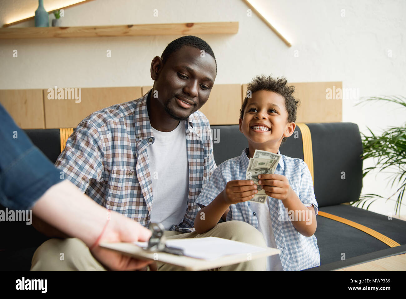 Child giving money to parent hi-res stock photography and images - Alamy