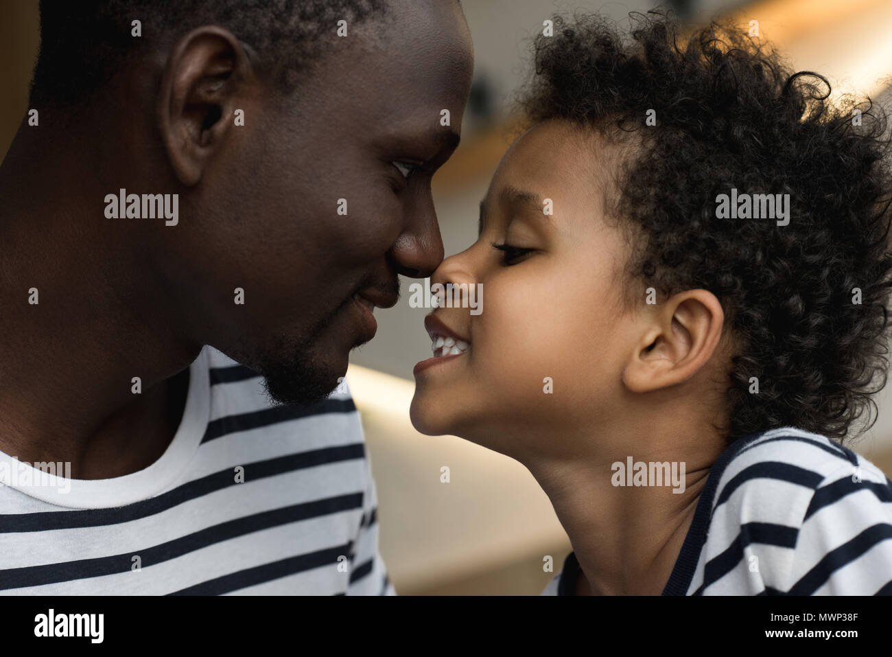 Close Up Portrait Of Happy African American Father And Son Touching