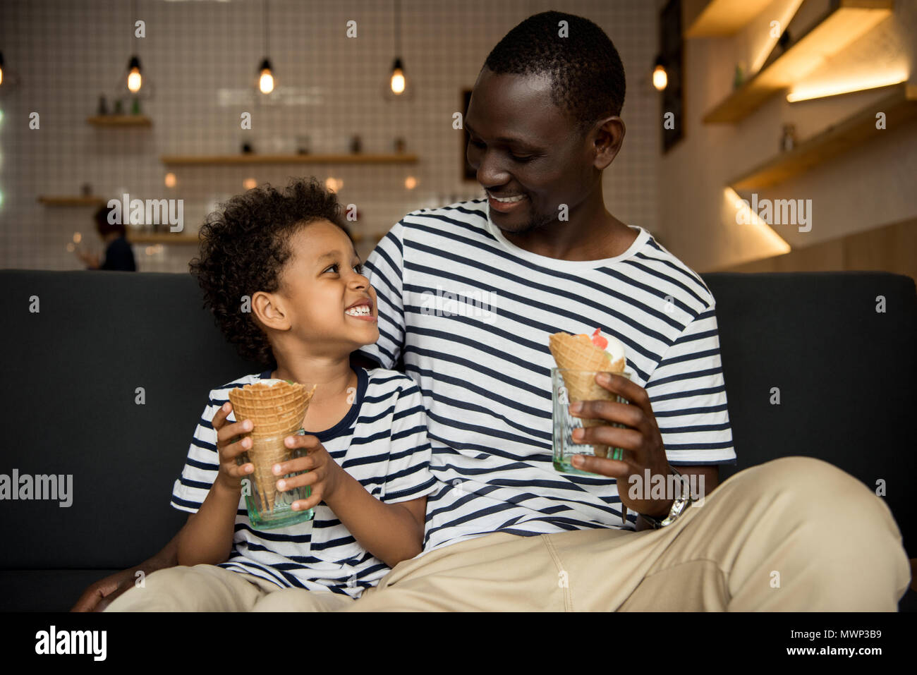 Beautiful Happy African American Father And Son Eating Ice Cream And
