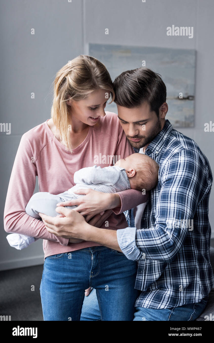 smiling parents hugging and holding ther little baby boy Stock Photo ...