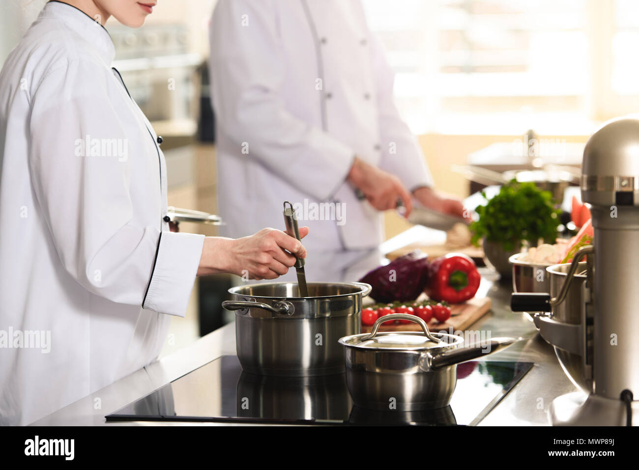 Professional team of cooks working together on modern kitchen Stock ...