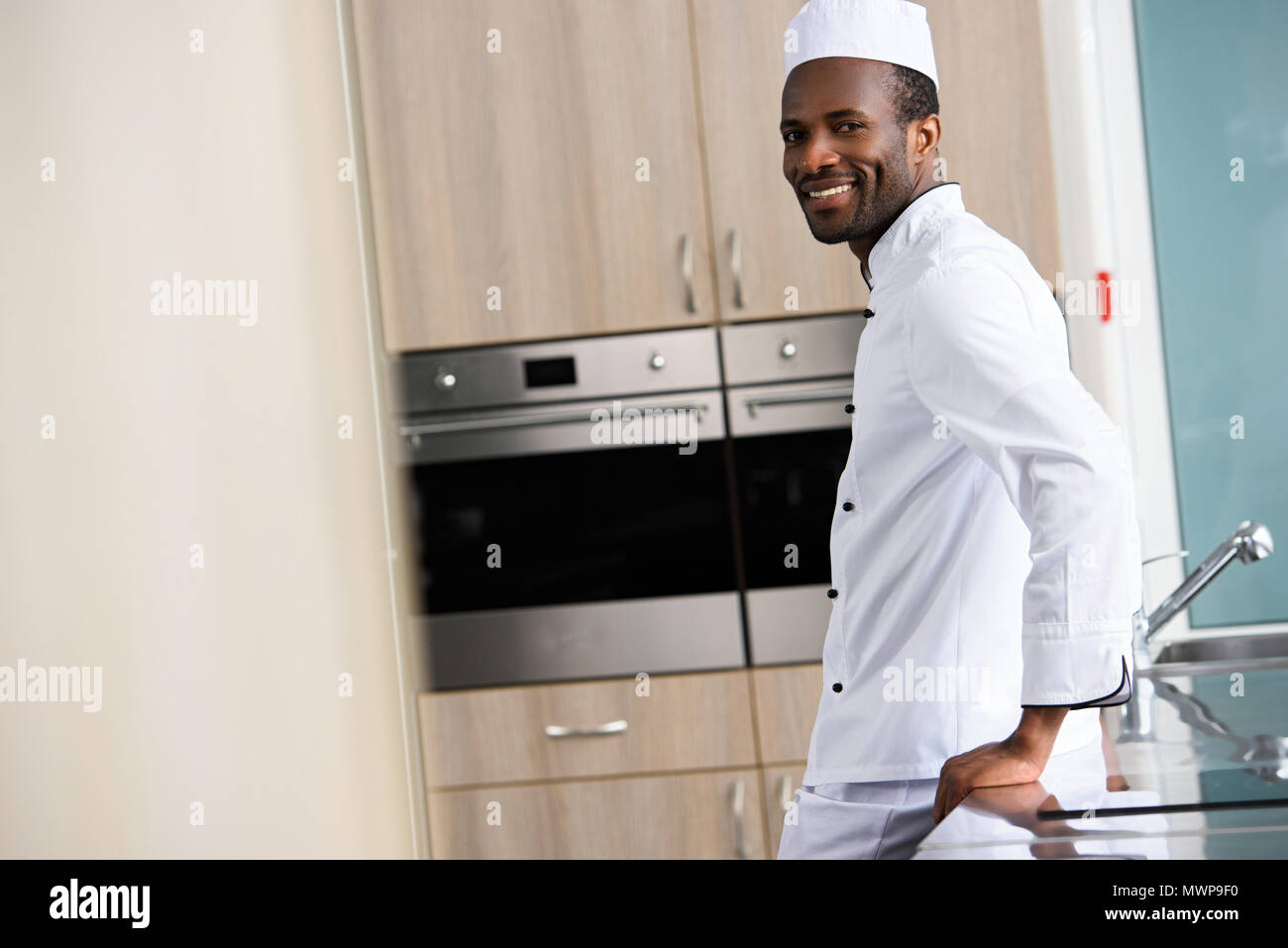 Handsome man leaning on counter hi-res stock photography and images - Alamy
