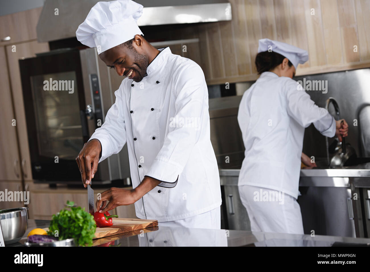 african american chef cutting bell pepper at restaurant kitchen Stock ...