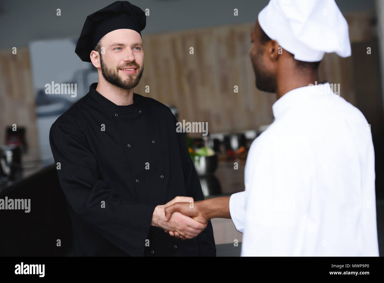 multicultural chefs shaking hands at restaurant kitchen Stock Photo - Alamy