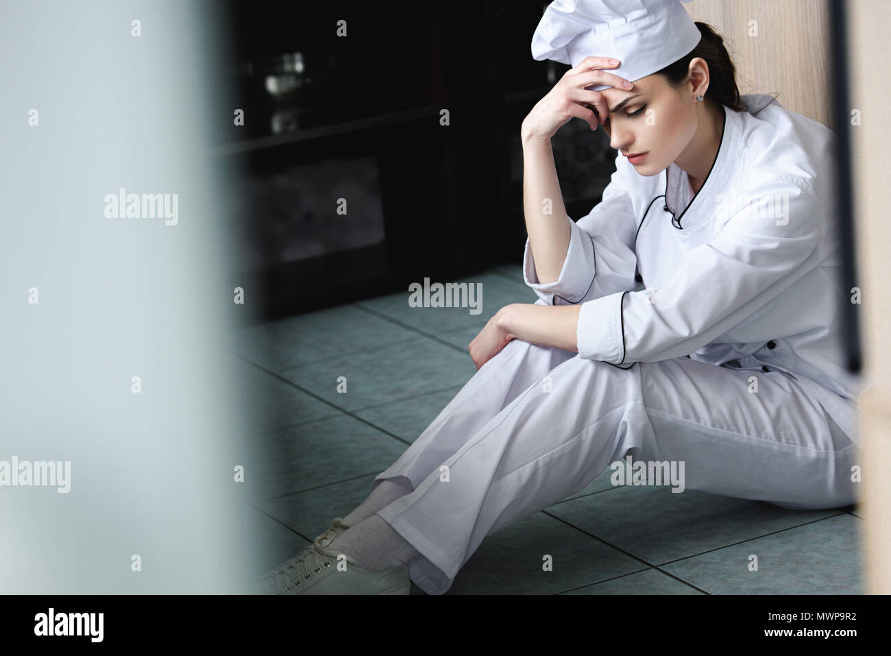 sad chef sitting on floor at restaurant kitchen Stock Photo - Alamy