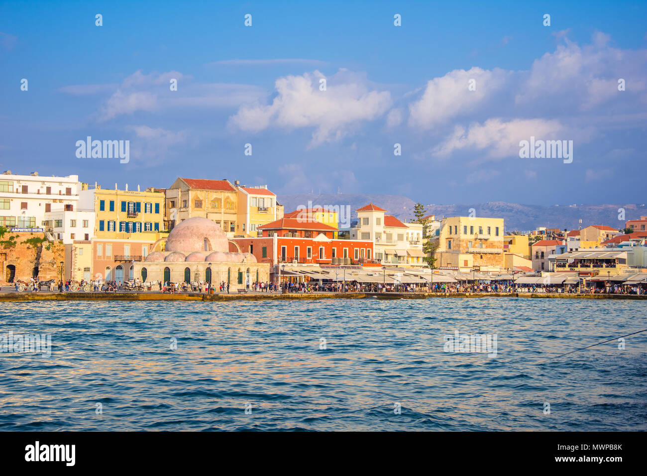 The beautiful old harbor of Chania with the amazing lighthouse, mosque ...