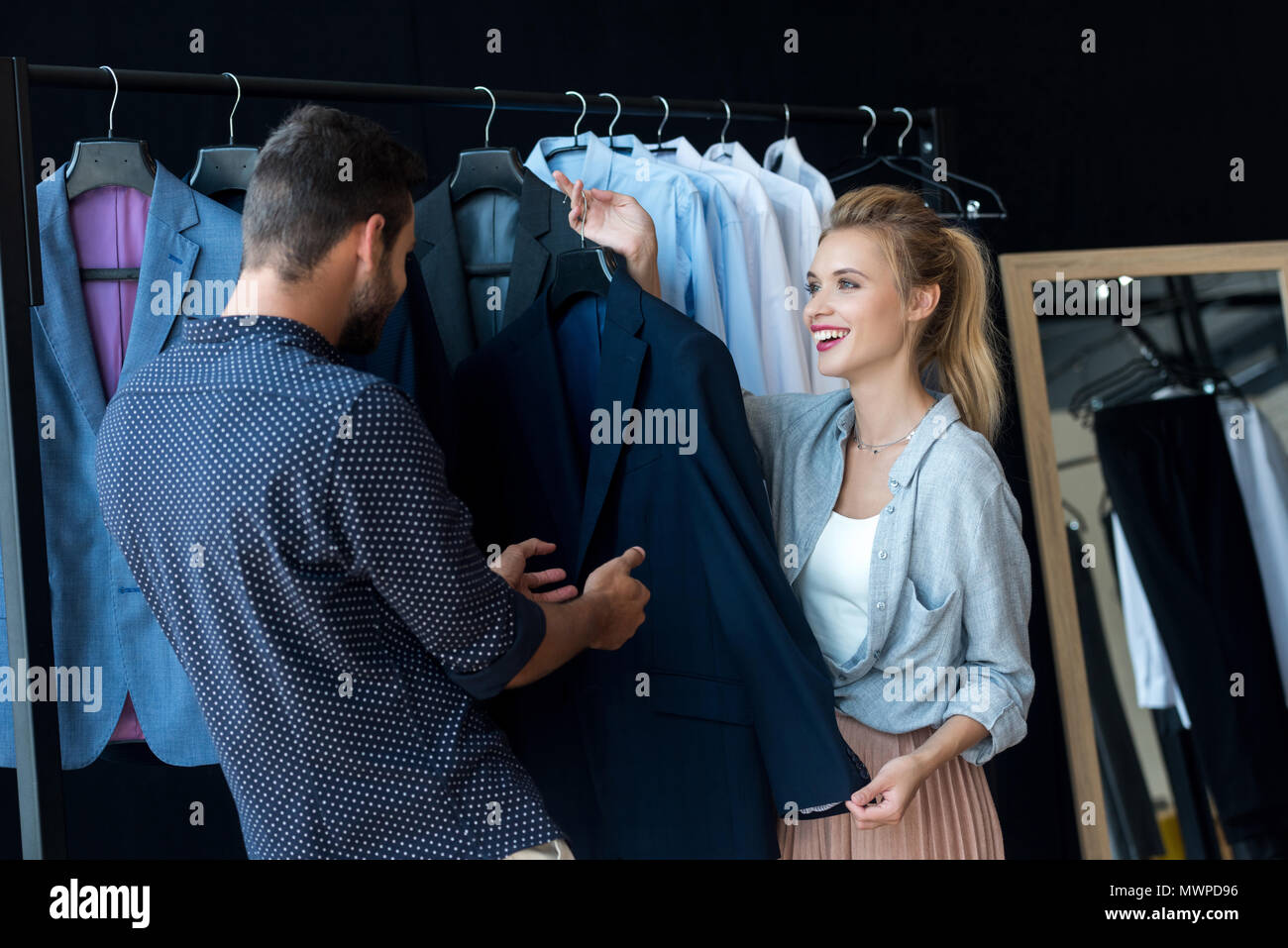 Young man woman choosing suit hi-res stock photography and images - Alamy
