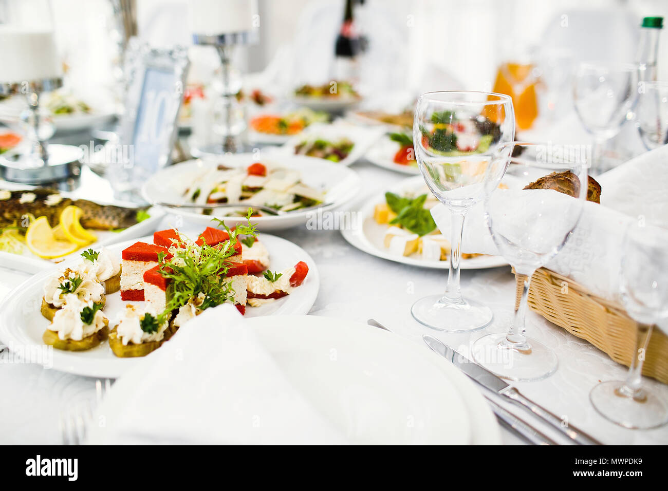 Catering table set service with silverware and glass stemware at ...