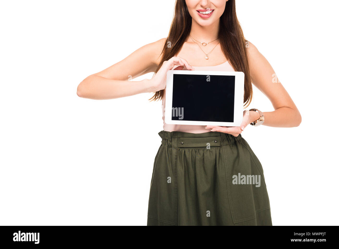 partial view of woman showing tablet with blank screen in hands ...