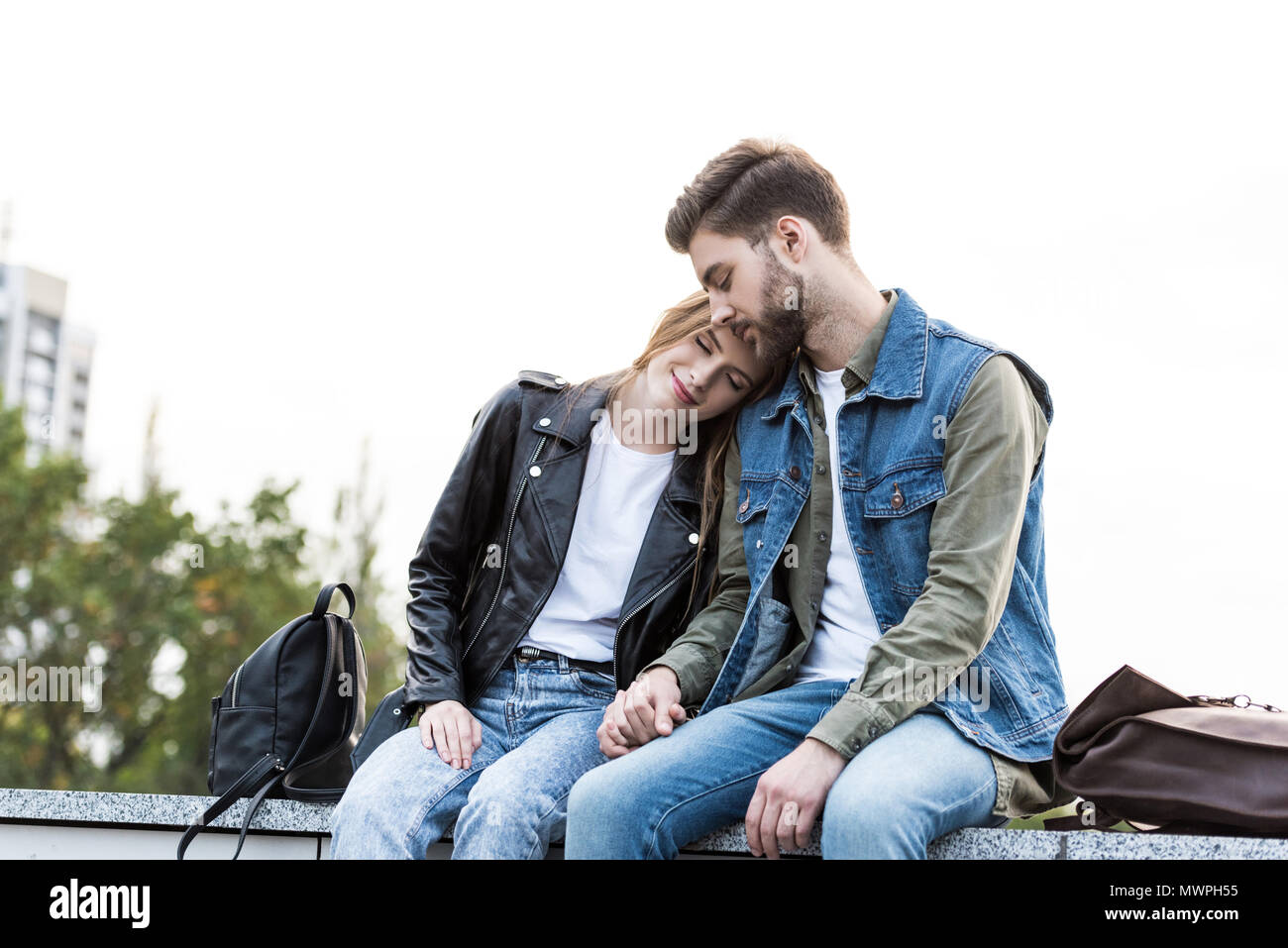 young couple holding hands while resting on parapet together Stock Photo - Alamy