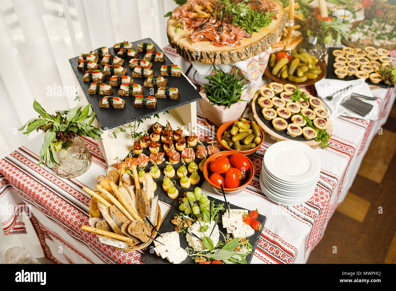 table with different type of snacks preparing for party Stock Photo - Alamy