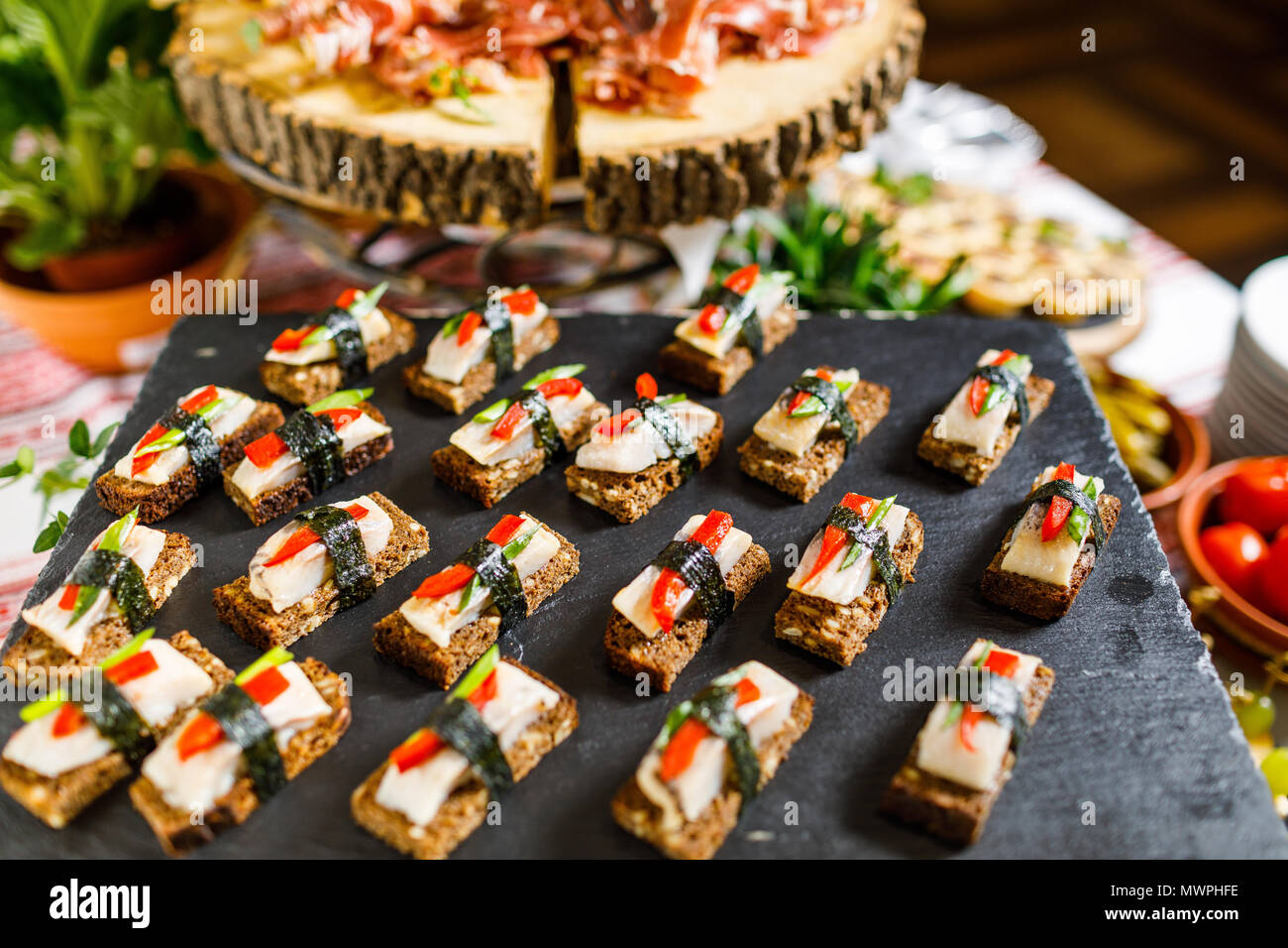 table with different food snacks preparing for party Stock Photo - Alamy
