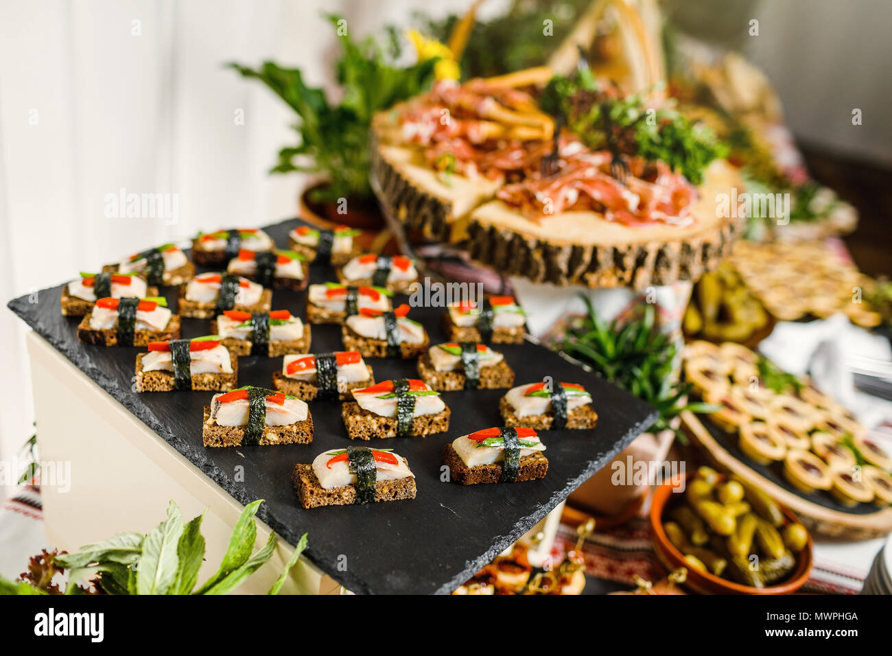 table with different type of snacks preparing for party Stock Photo - Alamy
