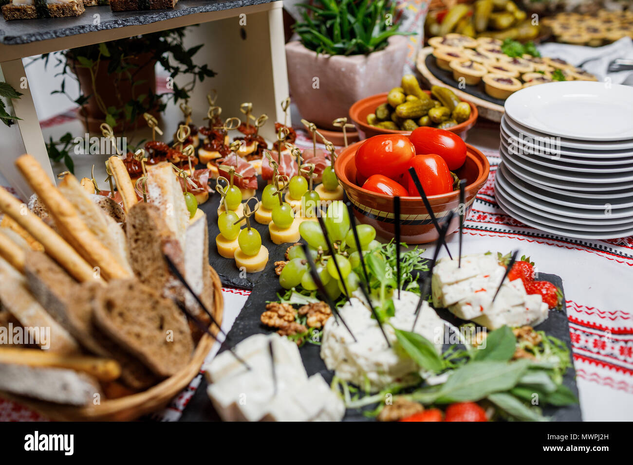 table with different type of snacks preparing for party Stock Photo - Alamy