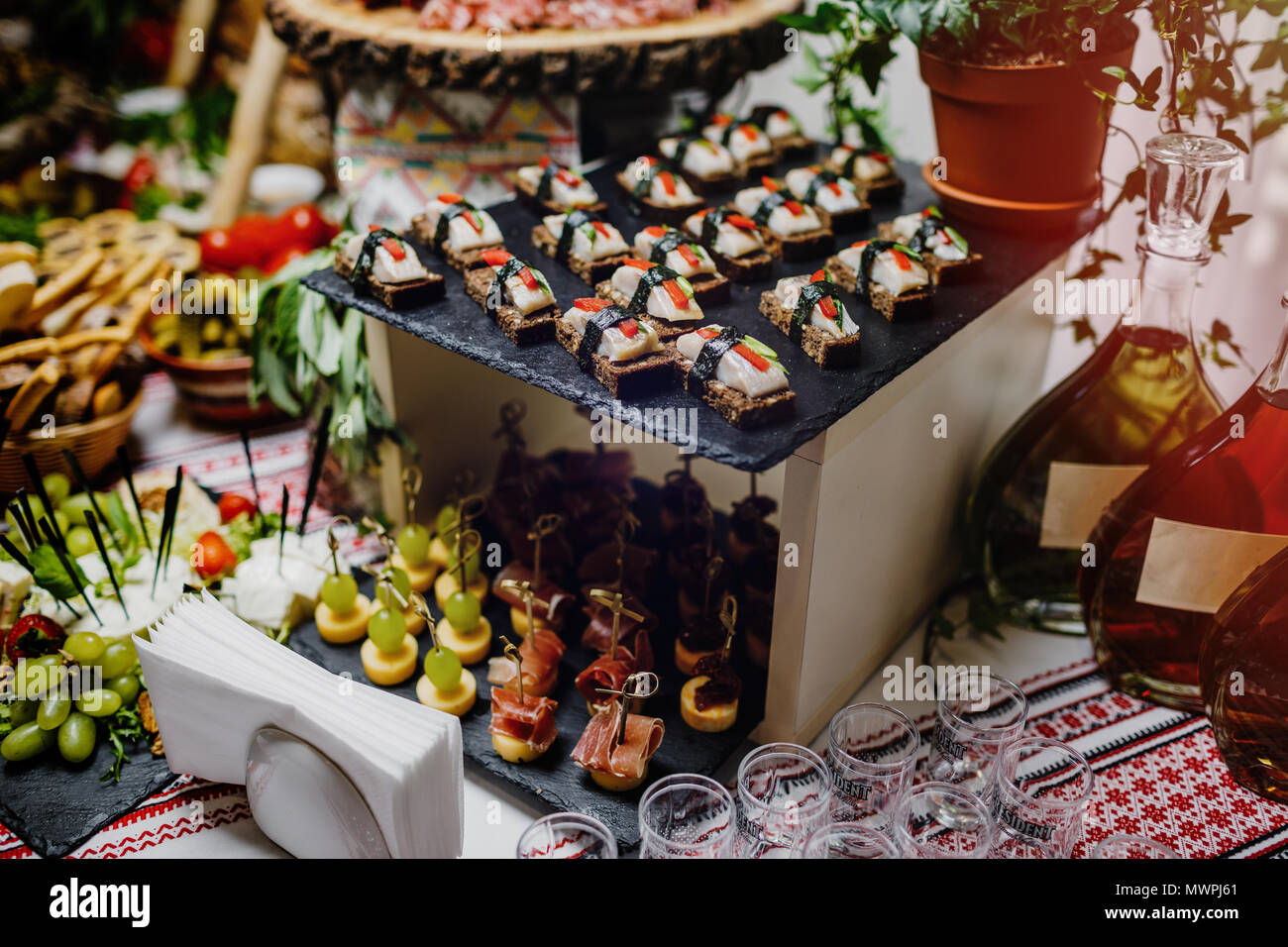 table with different type of snacks preparing for party Stock Photo - Alamy