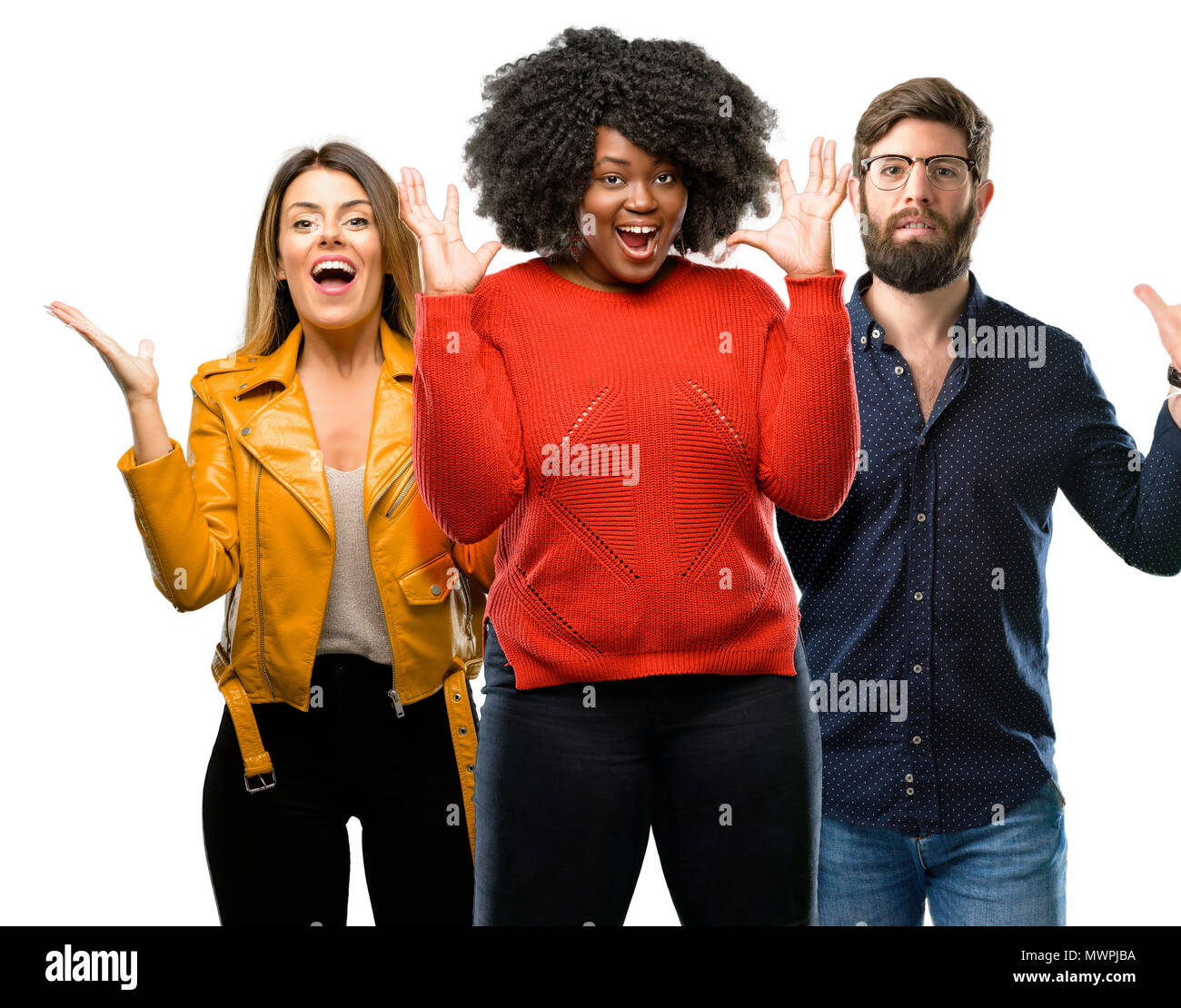 Group of three young men and women happy and surprised cheering ...