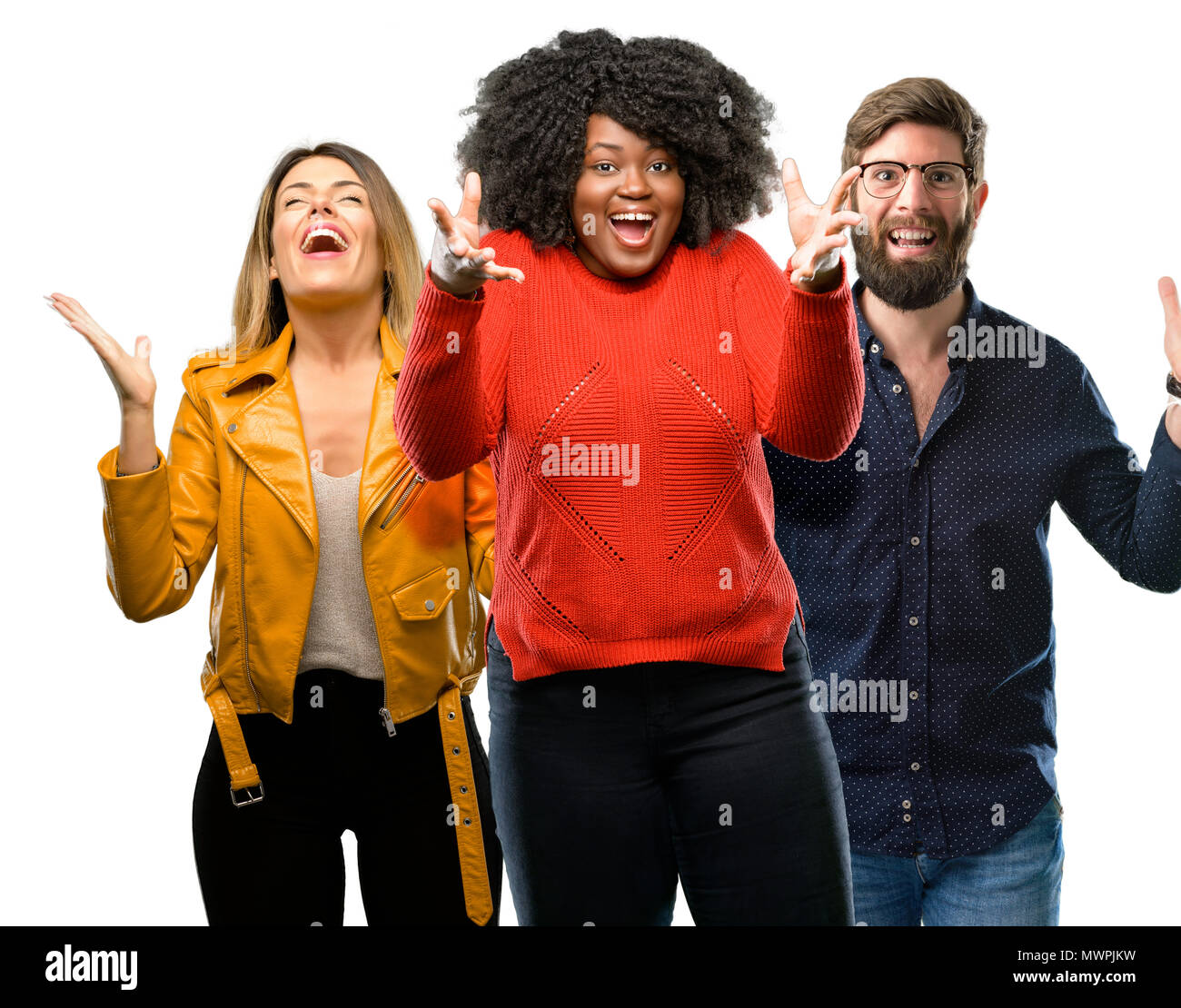 Group of three young men and women happy and surprised cheering ...