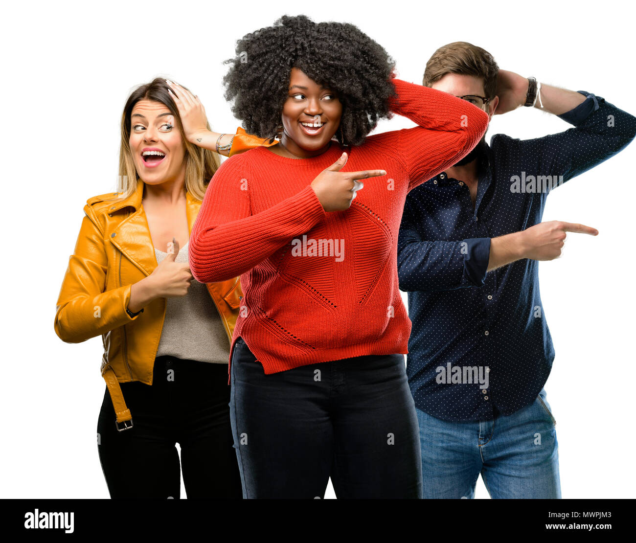 Group of three young men and women pointing away side with finger Stock ...