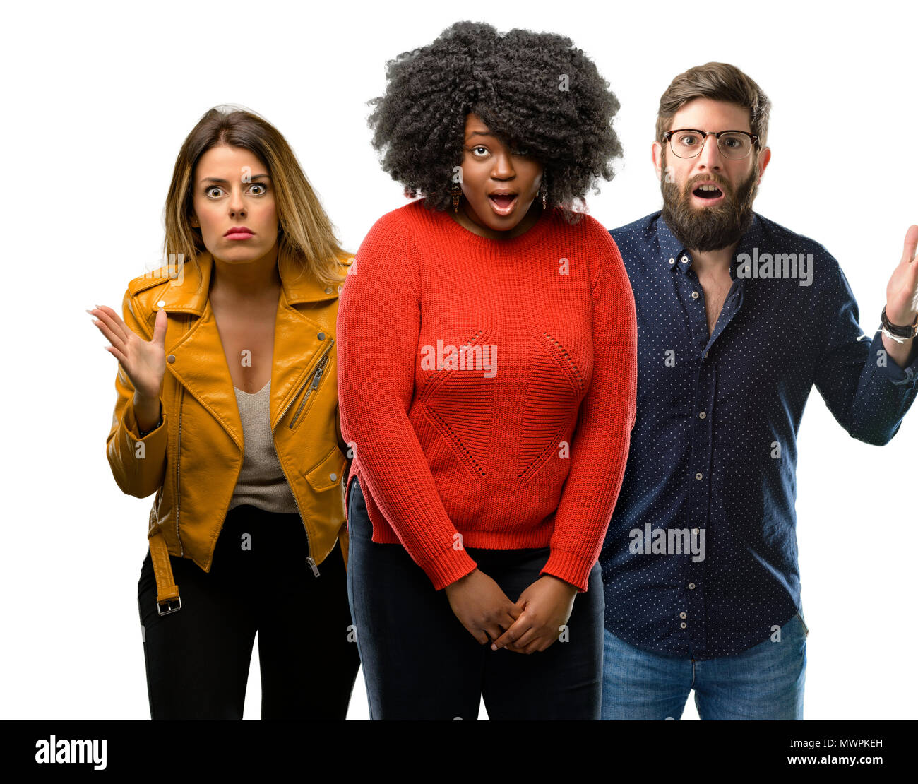 Group of three young men and women scared in shock, expressing panic ...