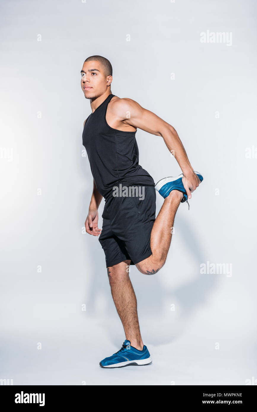 african american sportive man stretching legs Stock Photo - Alamy