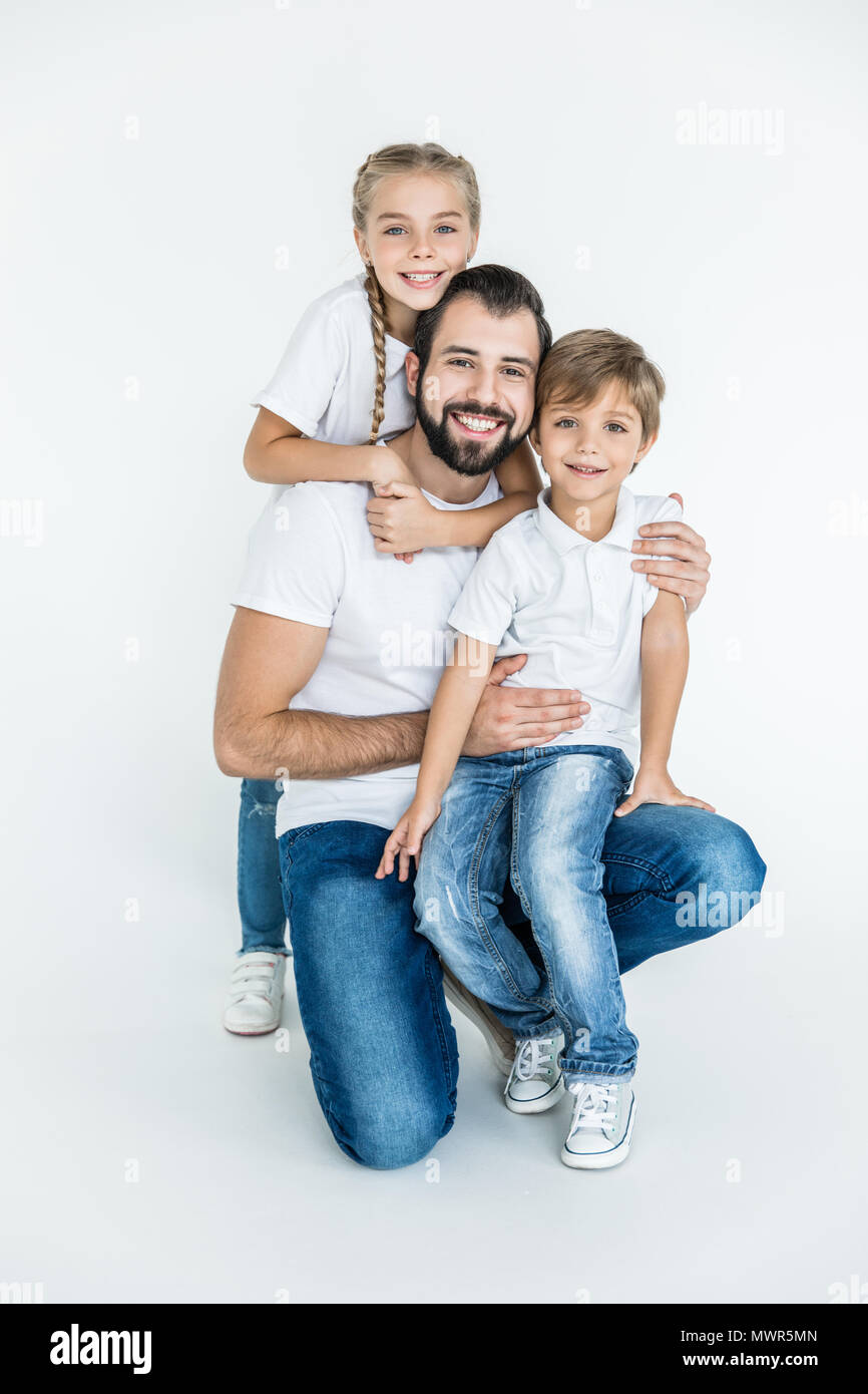 beautiful happy father with kids smiling at camera isolated on white ...