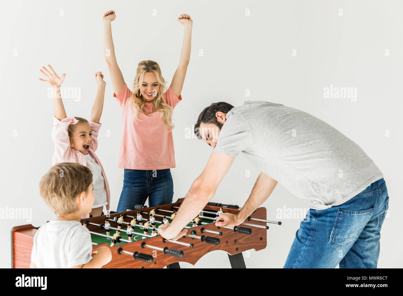 cheerful family playing foosball together isolated on white Stock Photo ...