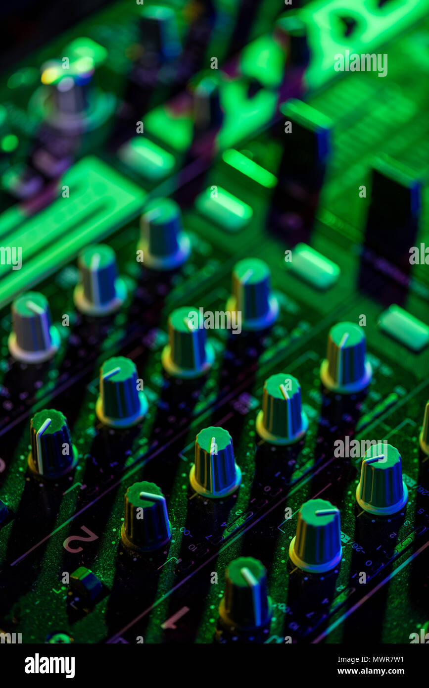 selective focus of sound mixer in nightclub with green light Stock ...