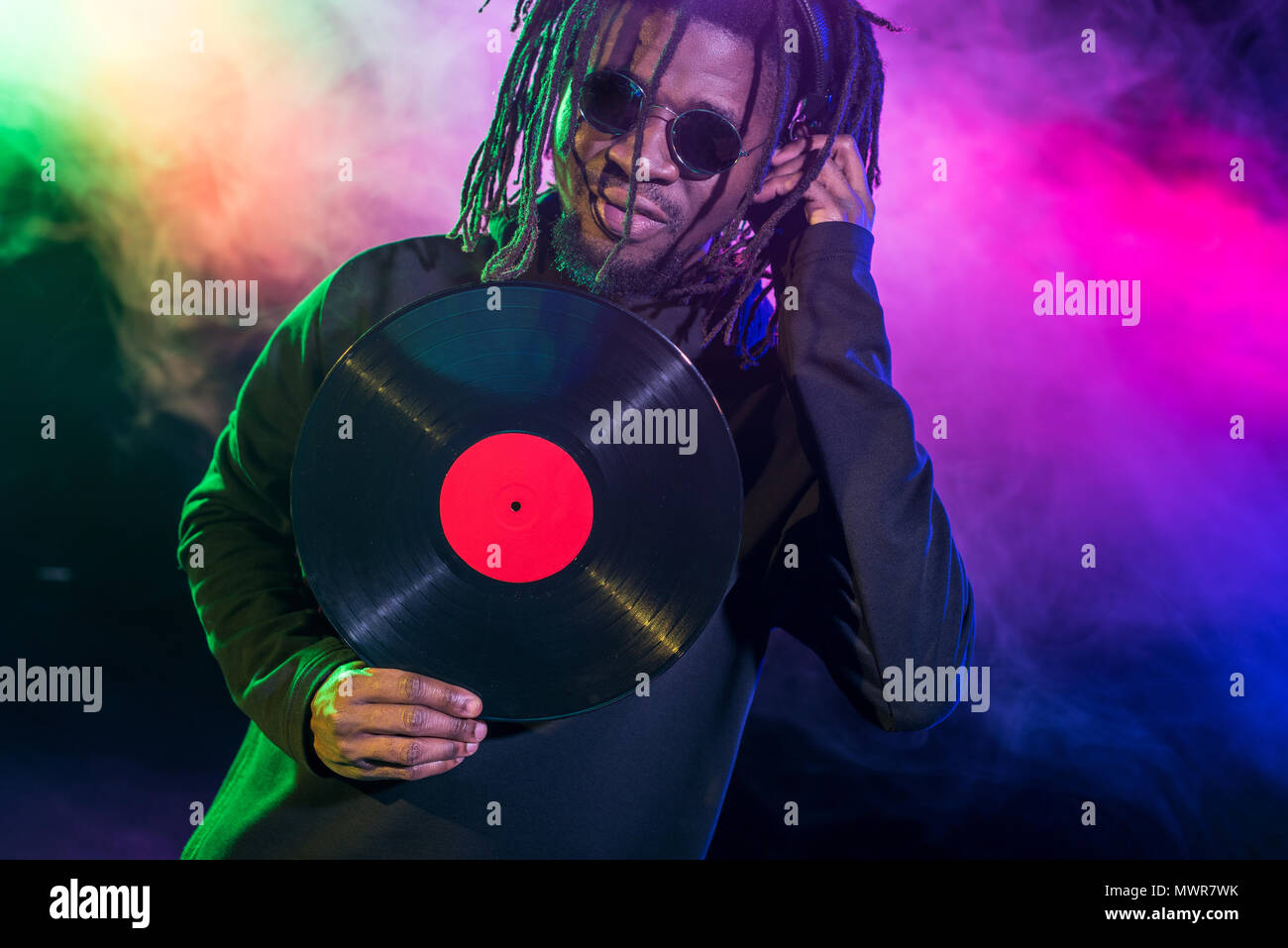 professional african american club DJ with vinyl in nightclub Stock ...