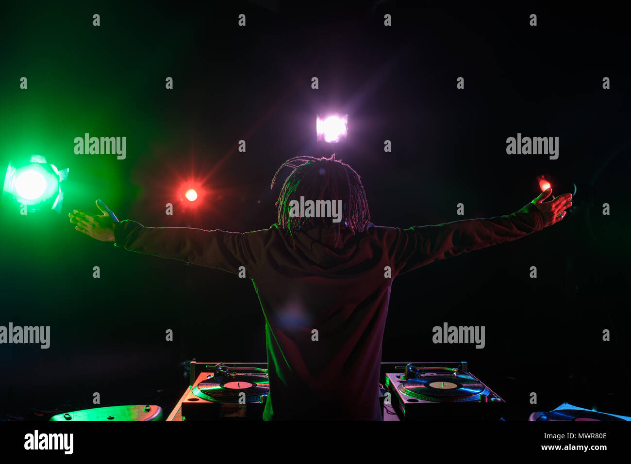 professional african american DJ with sound mixer in nightclub with ...