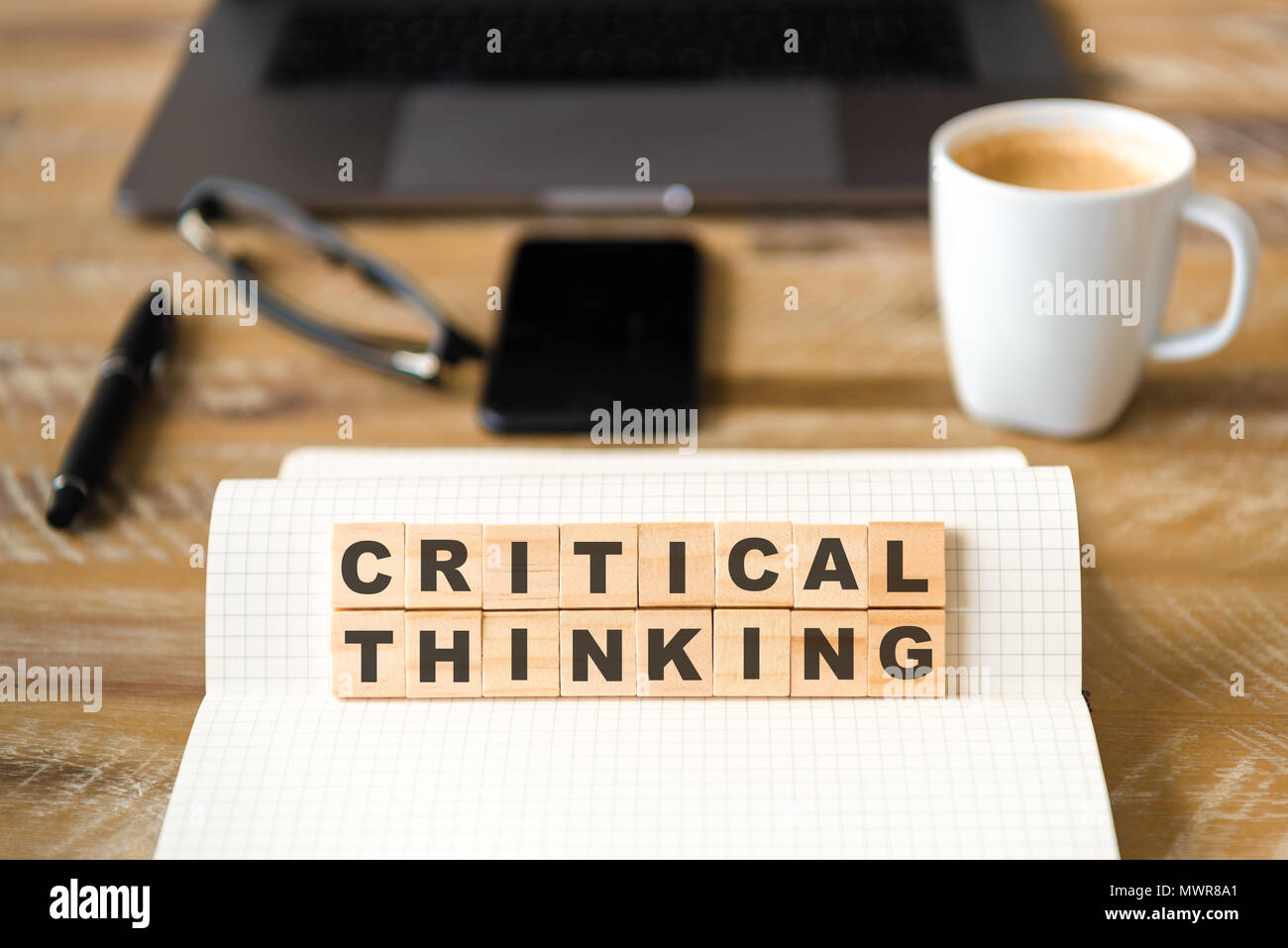 Closeup on notebook over wood table background, focus on wooden blocks ...